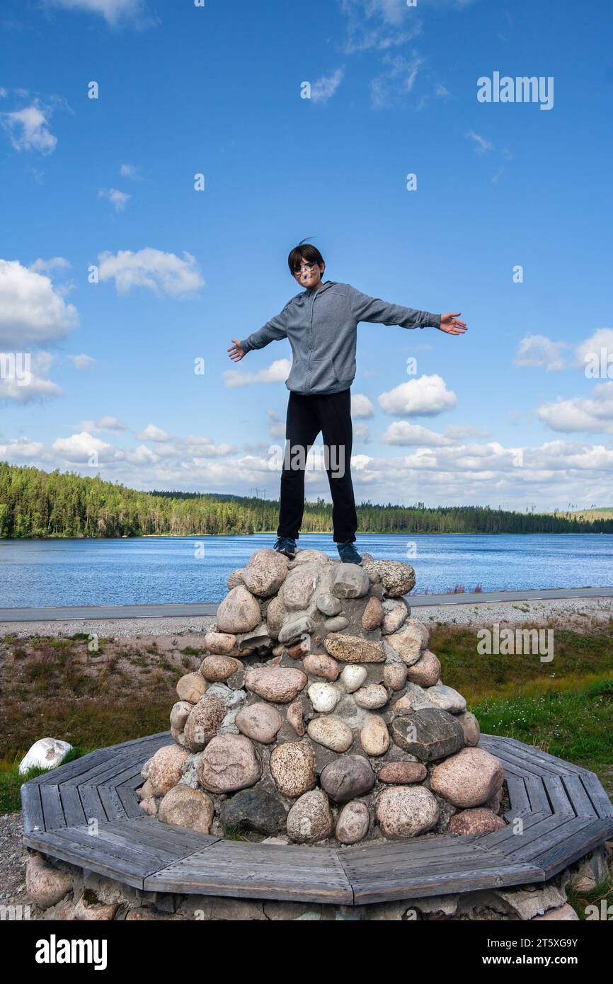 A happy teenager at the Arctic Circle in the Polecirkeln rest area ...