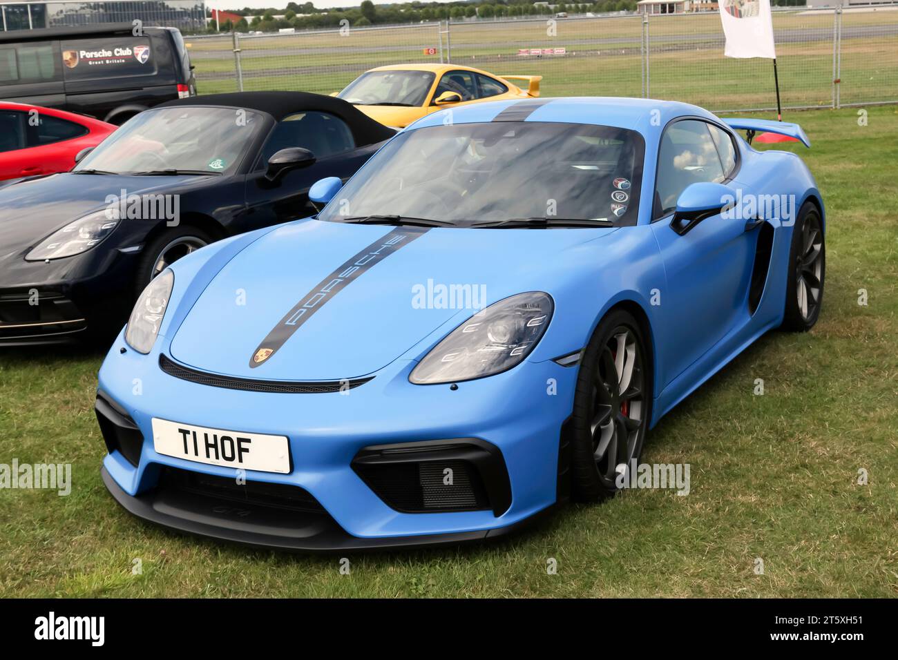 Three-quarters front view of a Blue, 2021, Porsche Cayman GT4, on ...