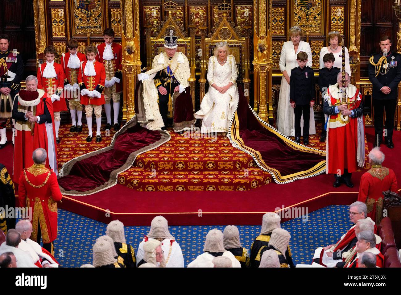 King Charles III, wearing the Imperial State Crown, sits besides Queen ...
