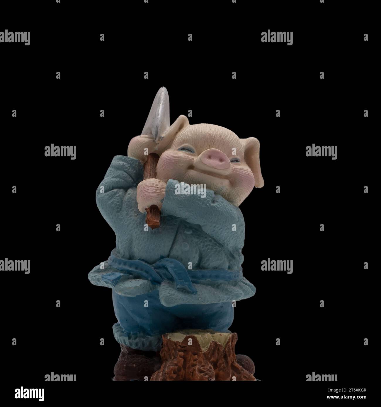 Toy pig chopping wood Stock Photo - Alamy