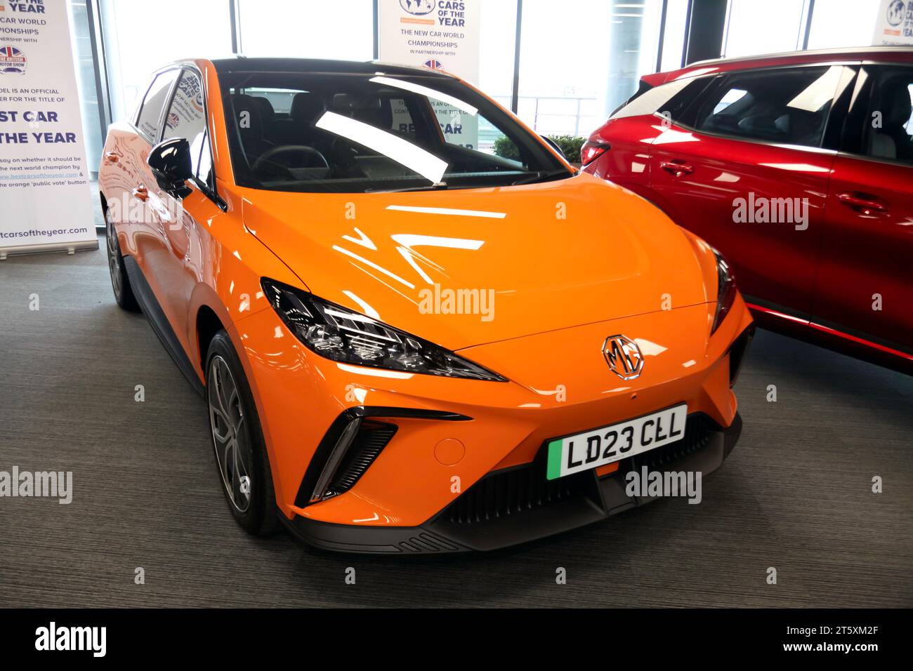 Three-quarters front view of an Orange, 2023, MG 4 extended range EV ...