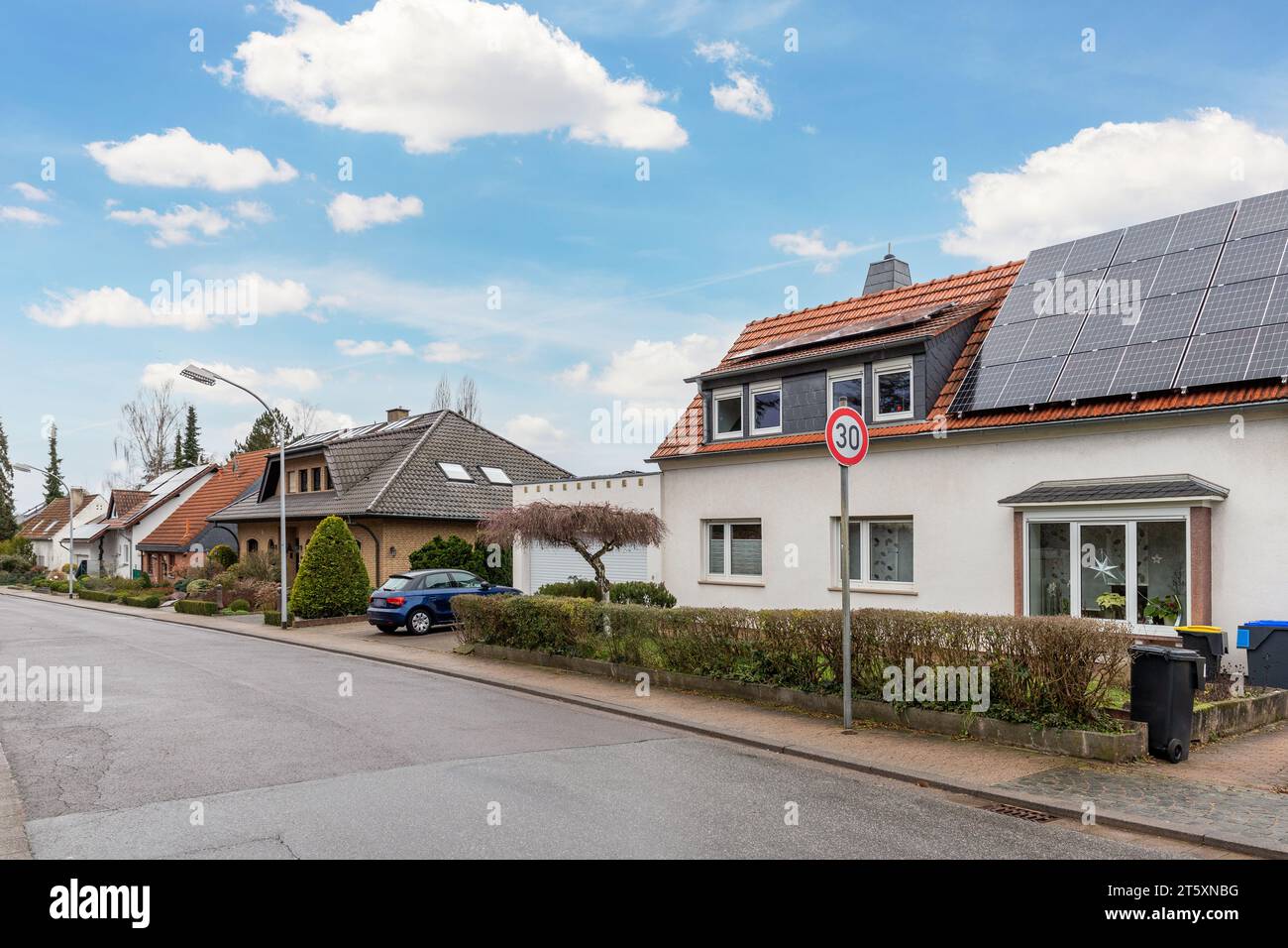 City street of single-family modern houses Germany against blue sky ...