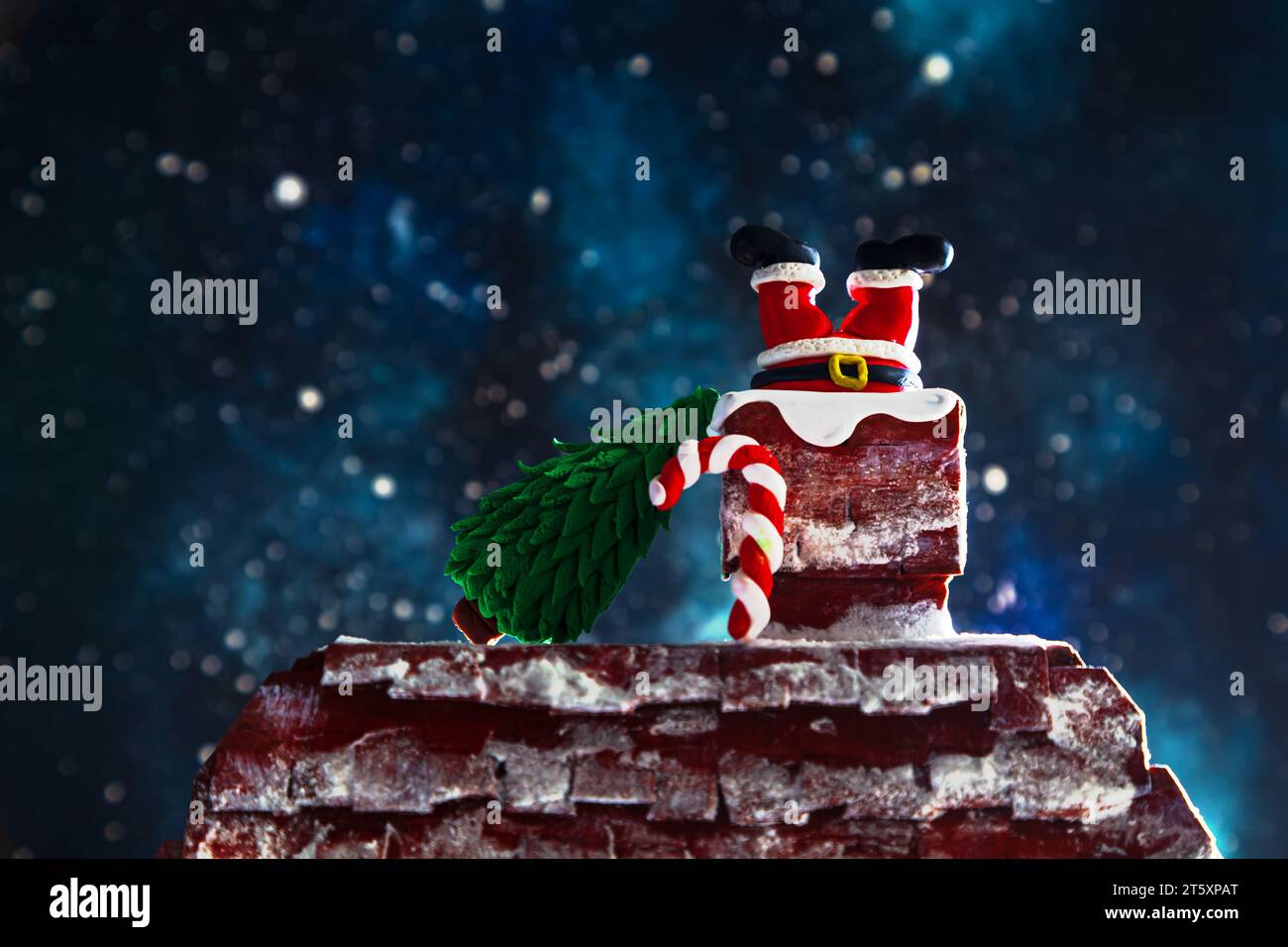 Santa's legs stick out of the chimney. Night, starry sky, Christmas ...