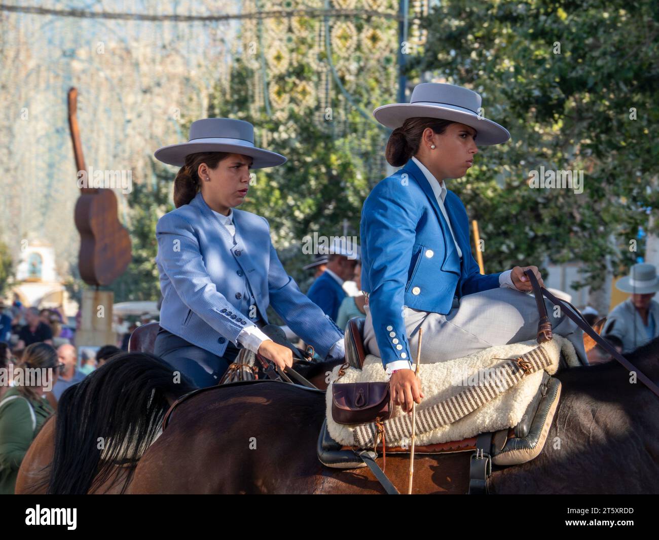 Groups of horse riders dressed in typical Andalusian costume, riding ...