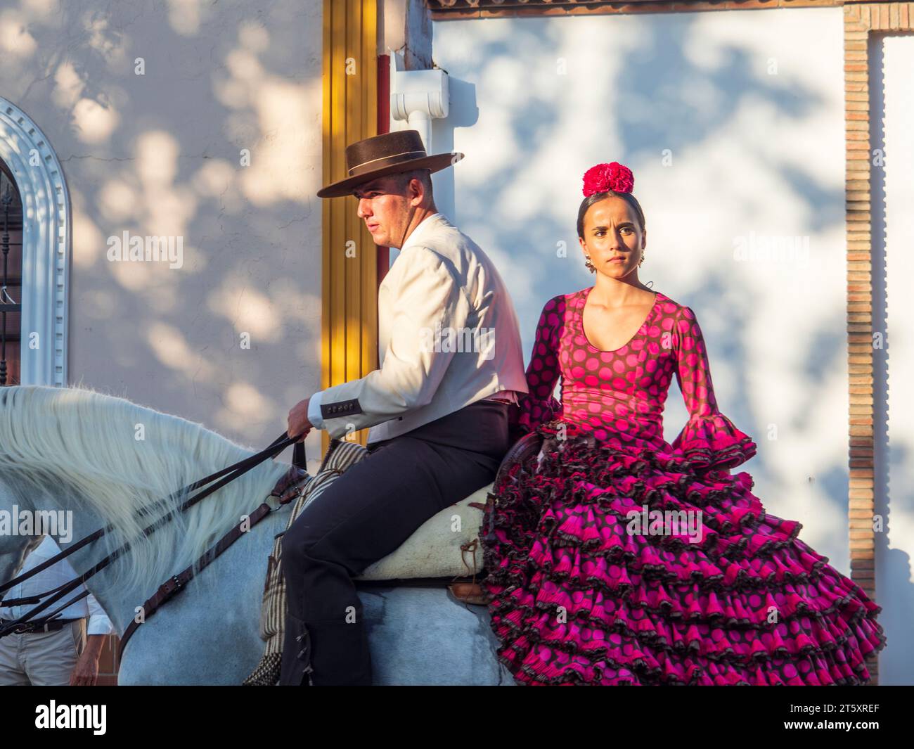 Groups of horse riders dressed in typical Andalusian costume, riding ...