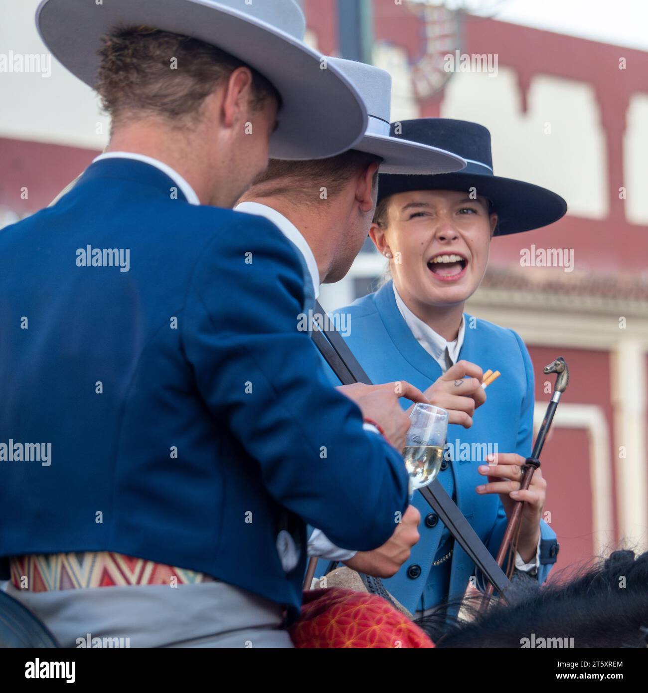 Groups of horse riders dressed in typical Andalusian costume, riding ...