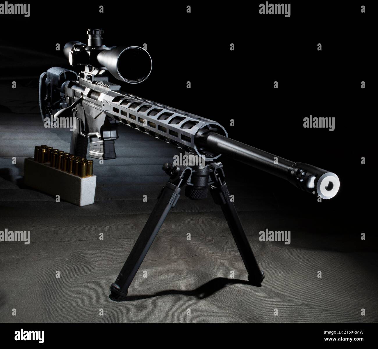 Precision rifle ideal for a sniper on a bipod with ammo on a dark ...