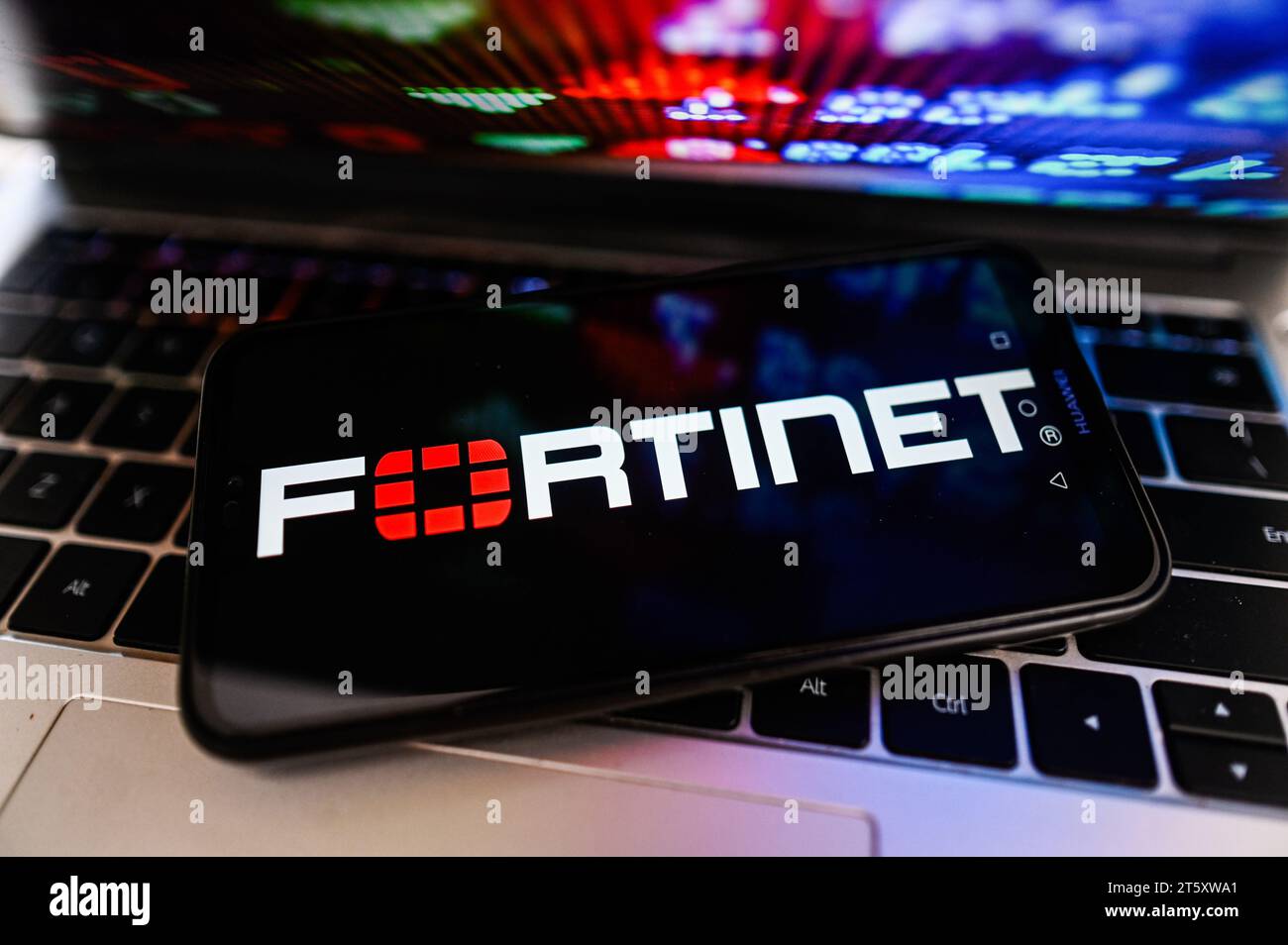 In this photo illustration, a Fortinet logo is displayed on a ...