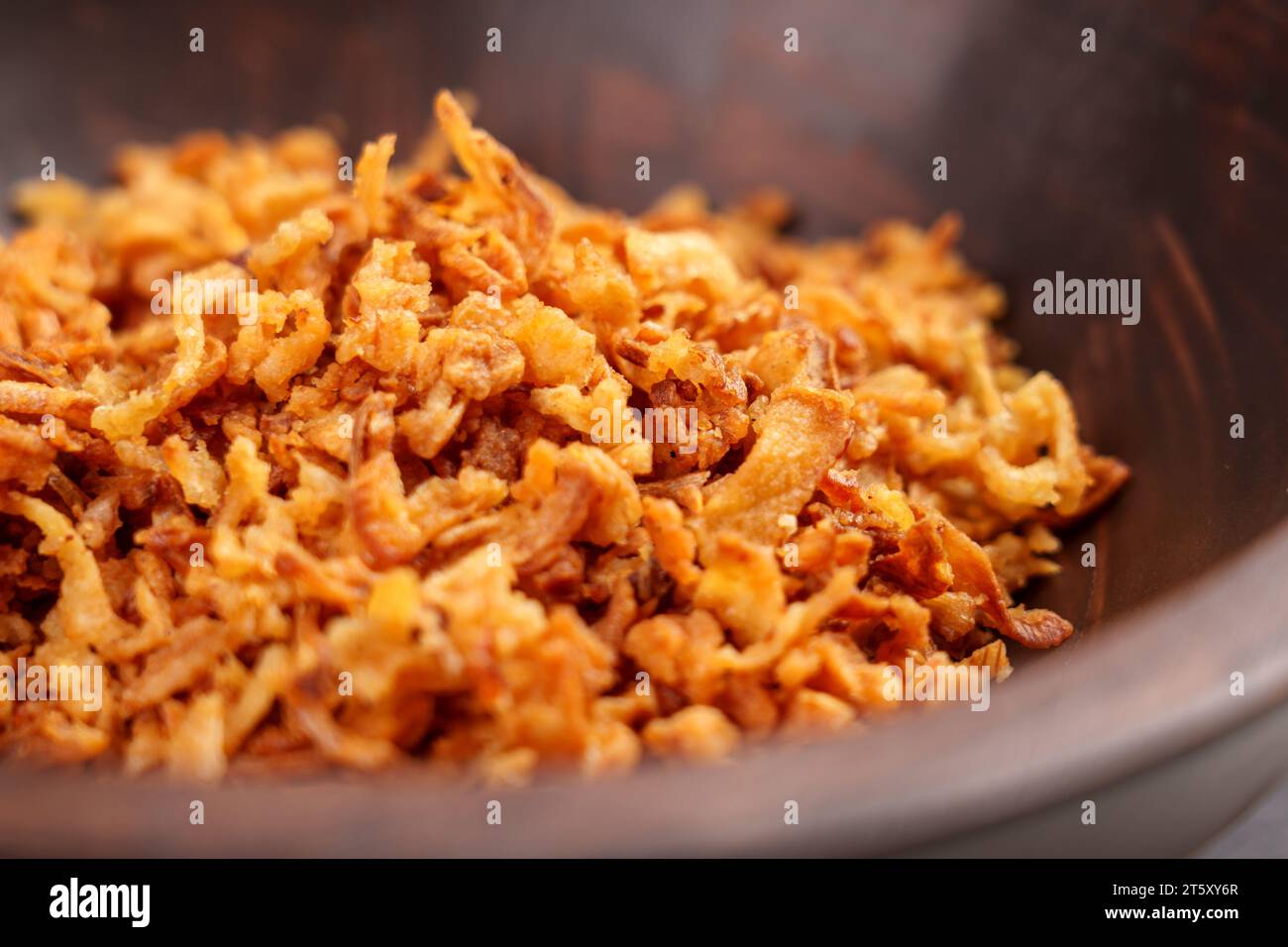 Deep fried shallots in wooden bowl. Roasted onion ingredient Stock ...