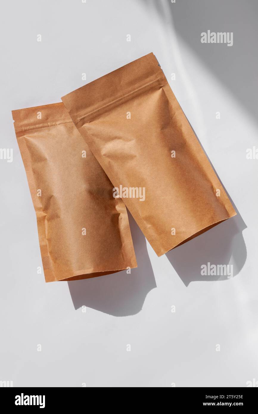 Brown kraft paper pouch bags with coffee beans top view with shadow ...