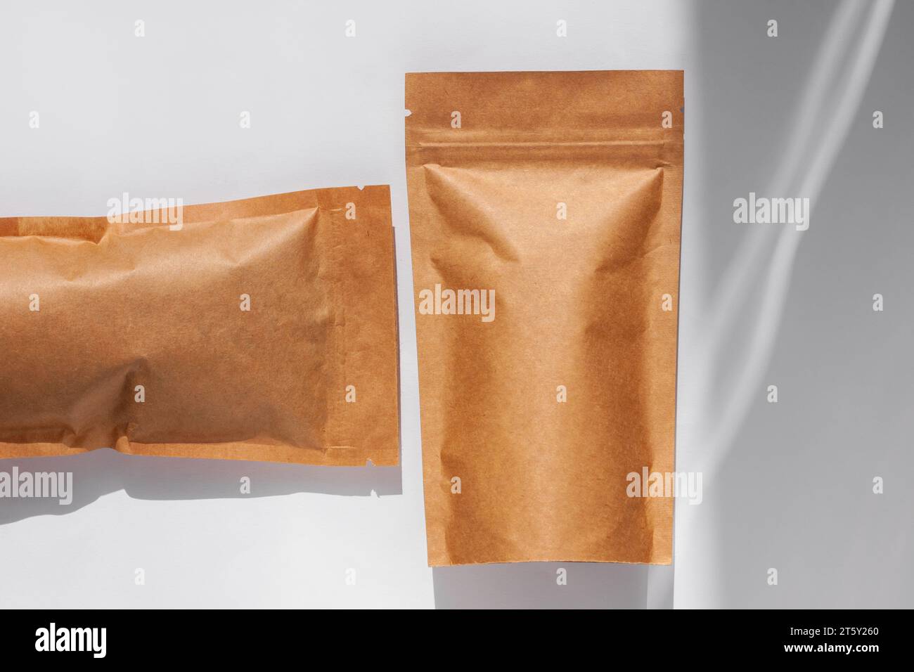 Brown kraft paper pouch bags with coffee beans top view with shadow ...
