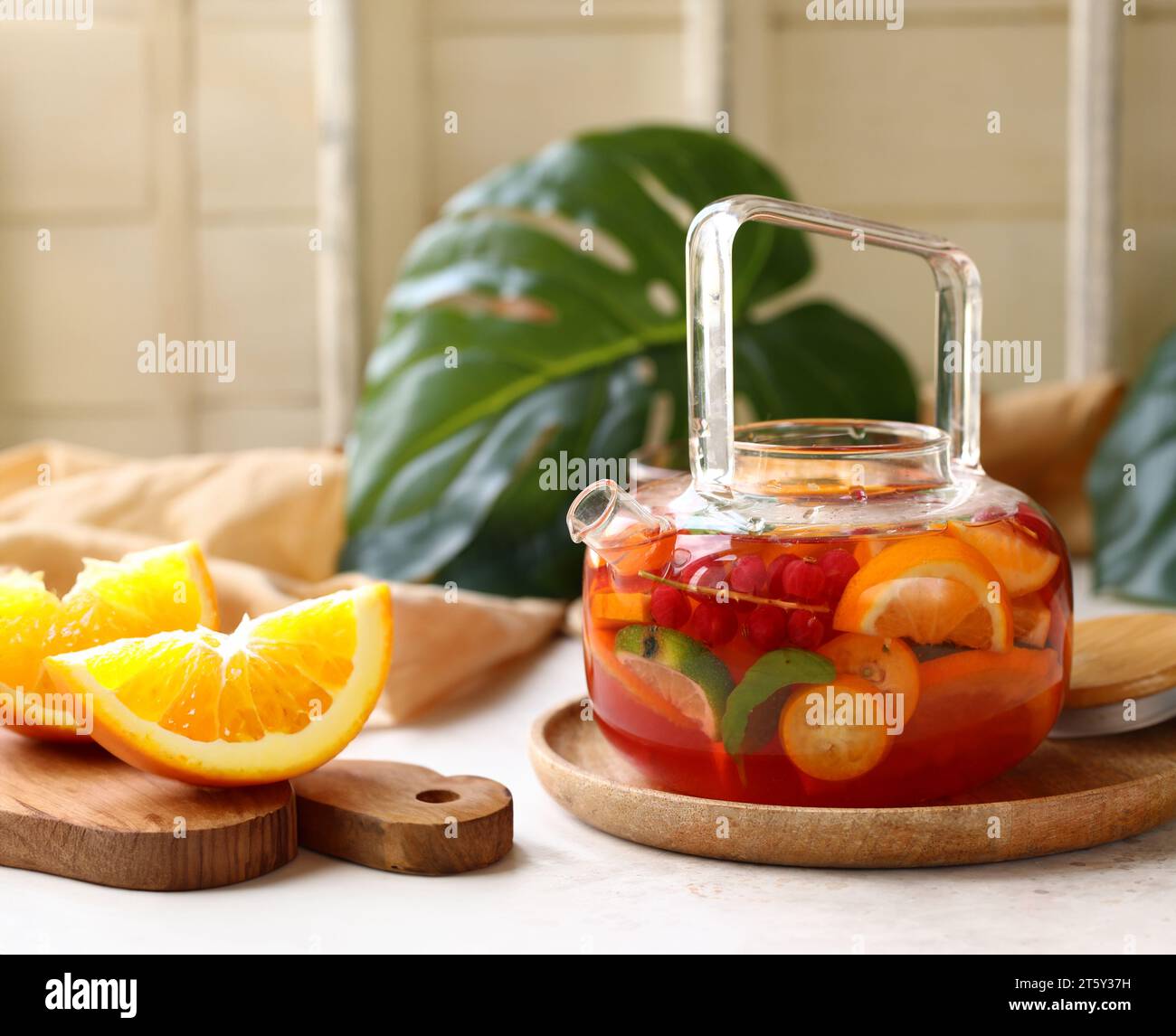 fruit berry citrus tea in a glass teapot Stock Photo - Alamy
