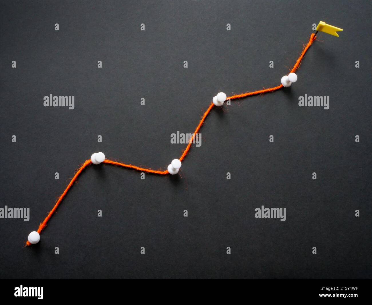 A thread in the form of growing graph as a symbol of business success ...