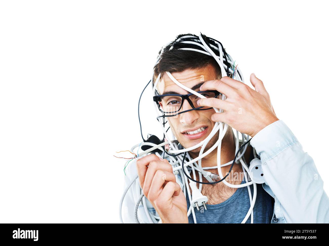 Portrait of man in glasses tangled in cables, wire and isolated on ...