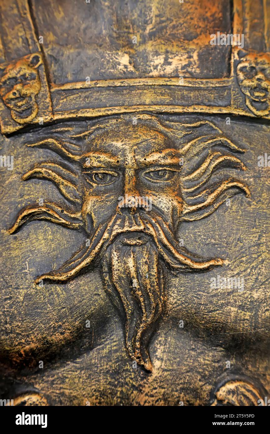 Character faces on copper metal plates Stock Photo - Alamy