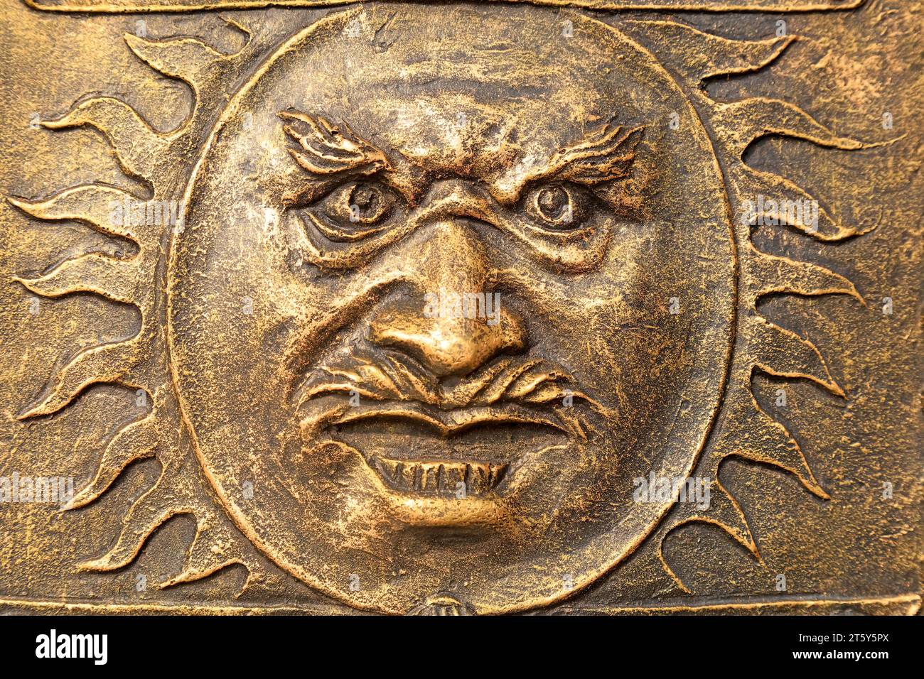 Character faces on copper metal plates Stock Photo - Alamy