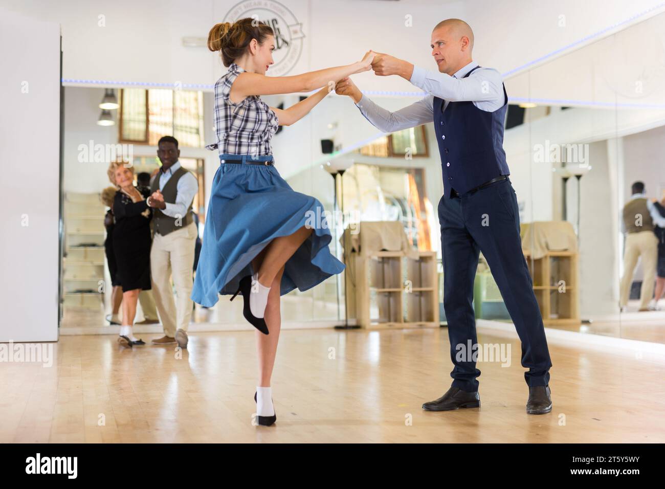 Man and woman performing jazz dance in dancing room Stock Photo - Alamy