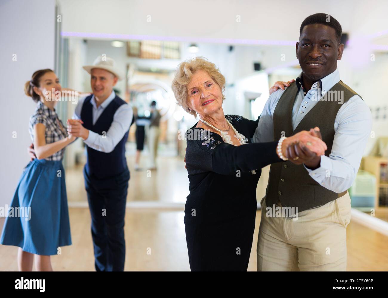 Man and mature woman learning to dance classical ballroom dance Stock ...