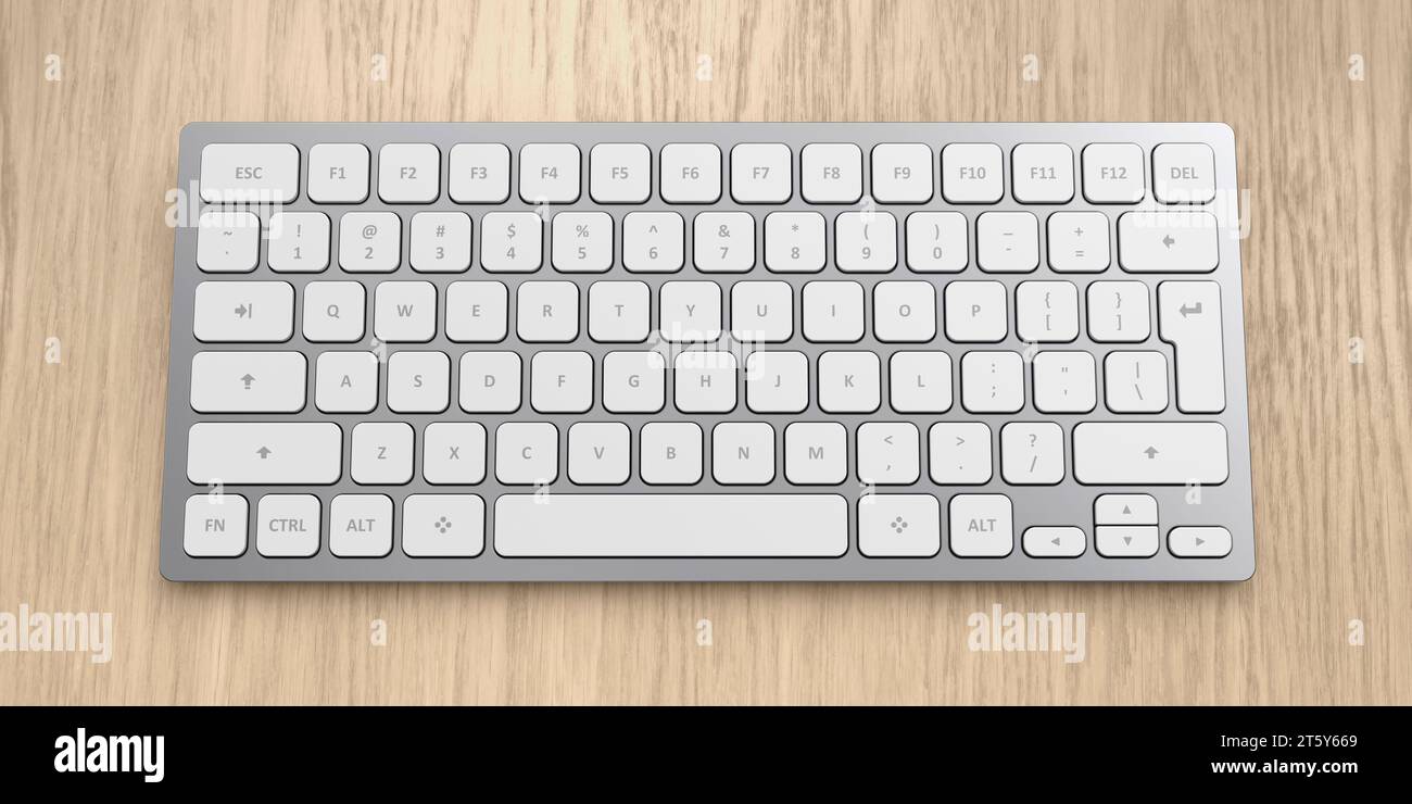 Modern wireless aluminum computer keyboard with white keys on wooden ...