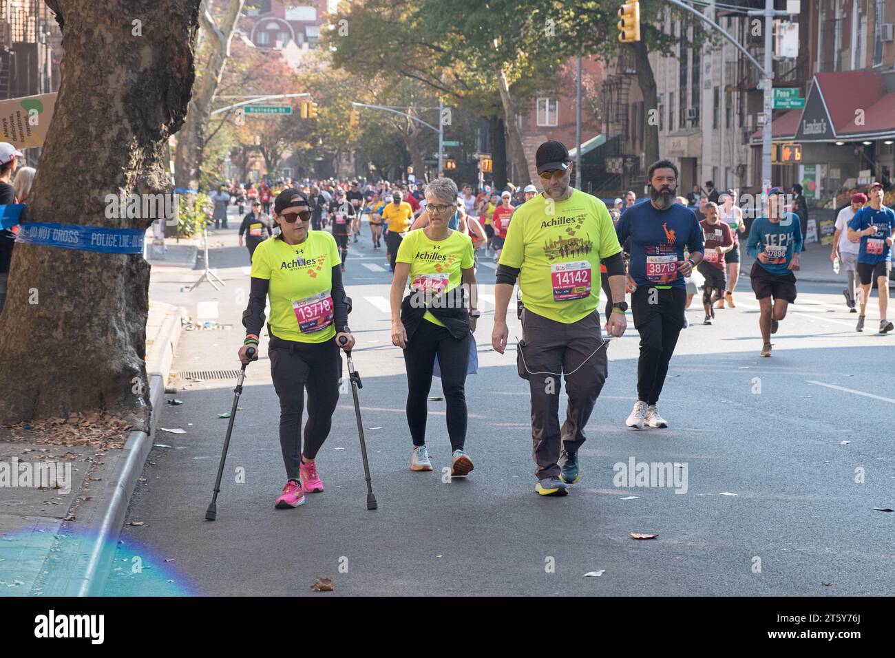 Two members of Achiiles International help a handicapped runner get ...