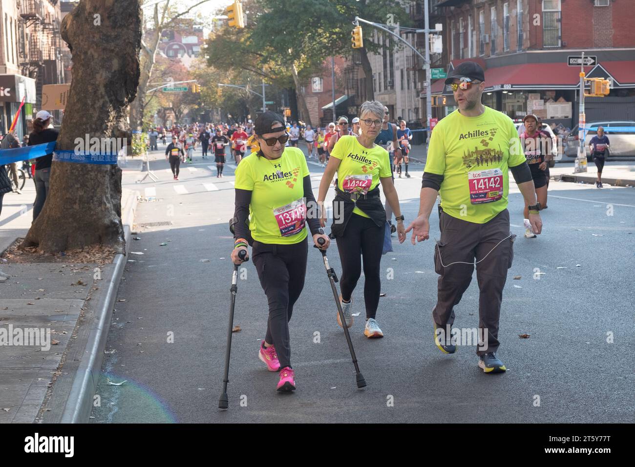 Two members of Achiiles International help a handicapped runner get ...
