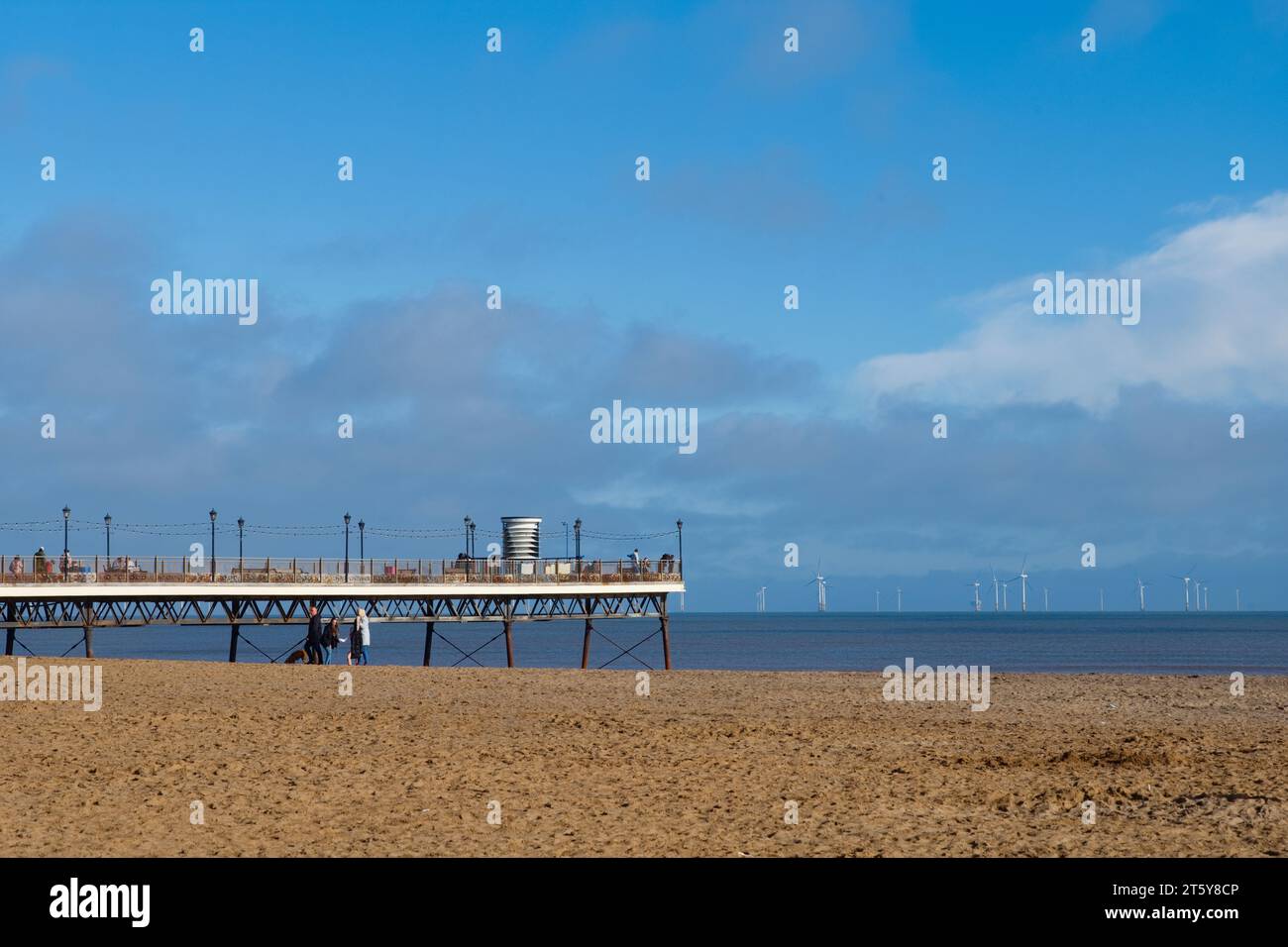 View towards Skegness pier with wind turbines in the North Sea behind Stock Photo - Alamy
