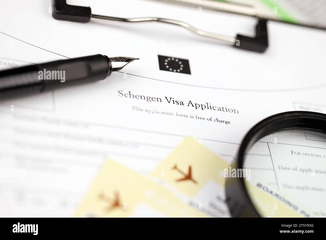Schengen visa application on A4 tablet lies on office table with pen ...
