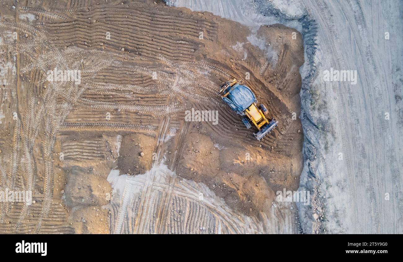 The tractor digs the ground. View from a drone. Excavation Stock Photo ...