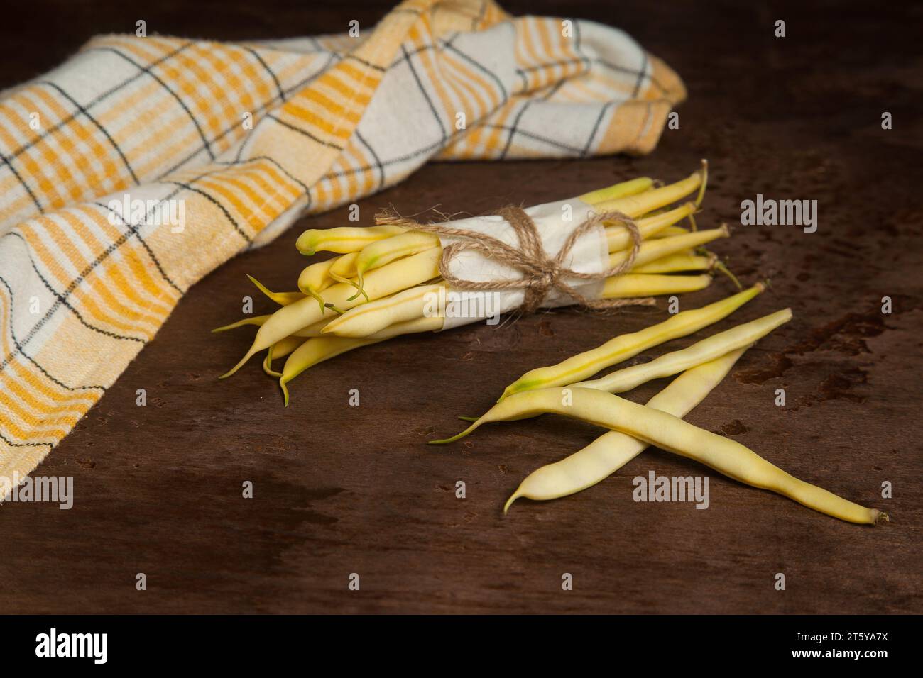 Bunch and several pods of raw yellow pods of haricot with yellow ...