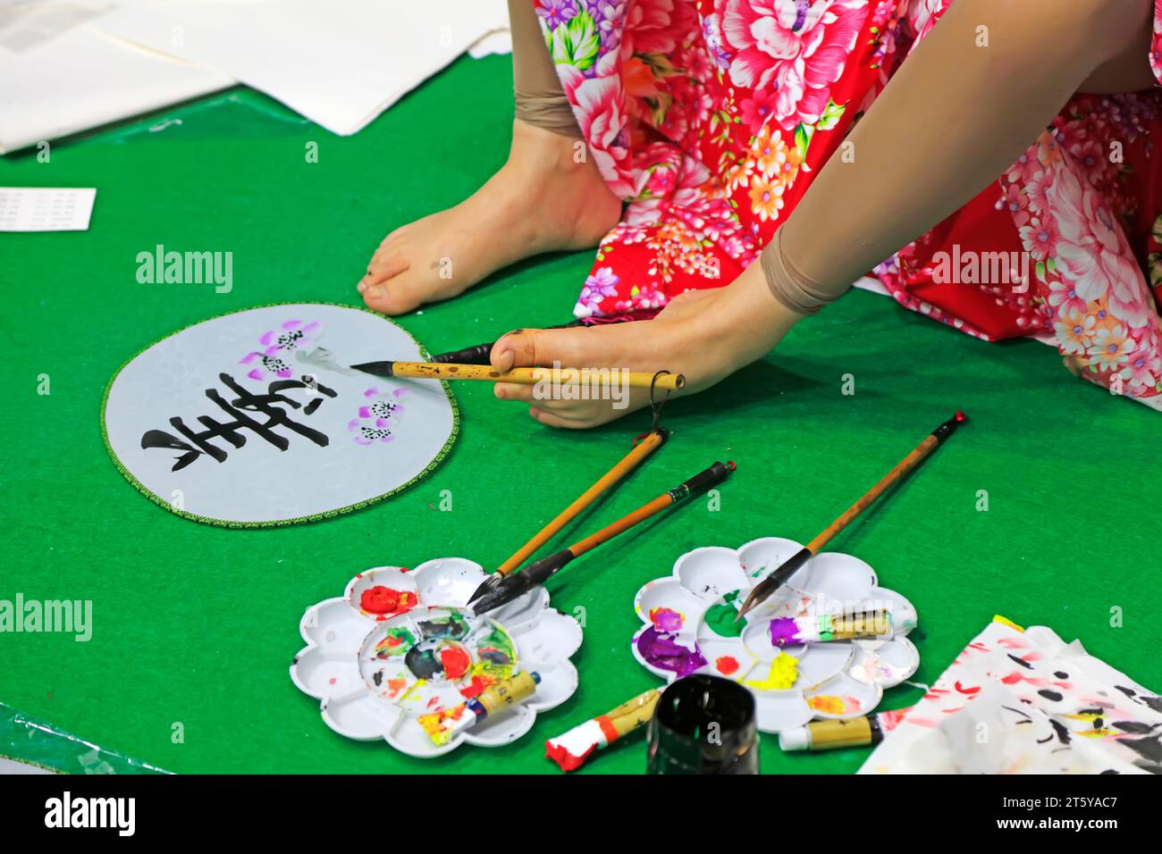 A woman writing with their feet, closeup of photo Stock Photo - Alamy