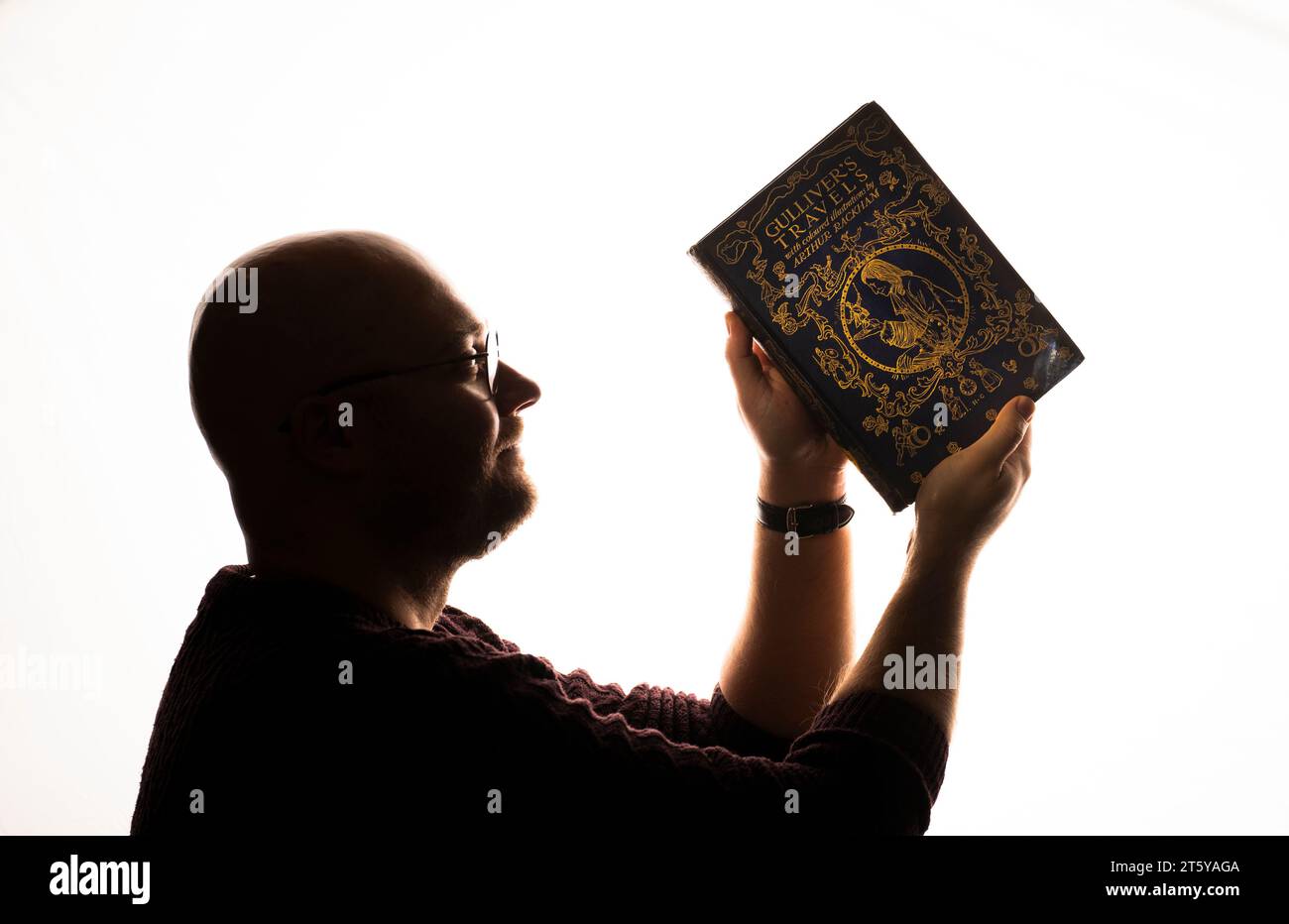 Librarian Josh Flint holds a vintage Gulliver's Travels book with ...