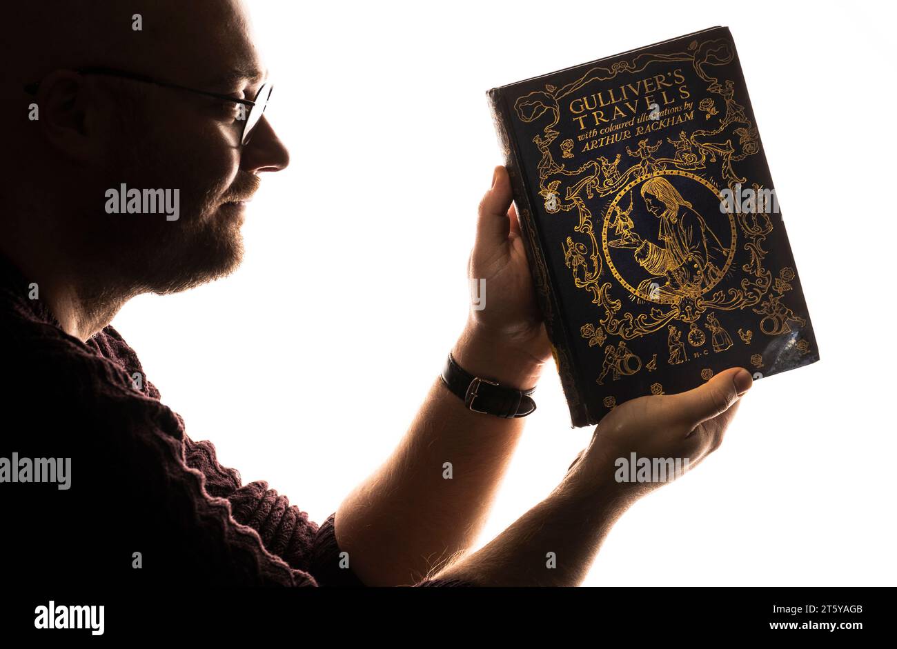 Librarian Josh Flint holds a vintage Gulliver's Travels book with ...