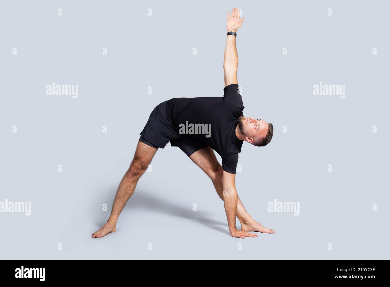 Calm handsome millennial european guy with beard in sportswear practice ...