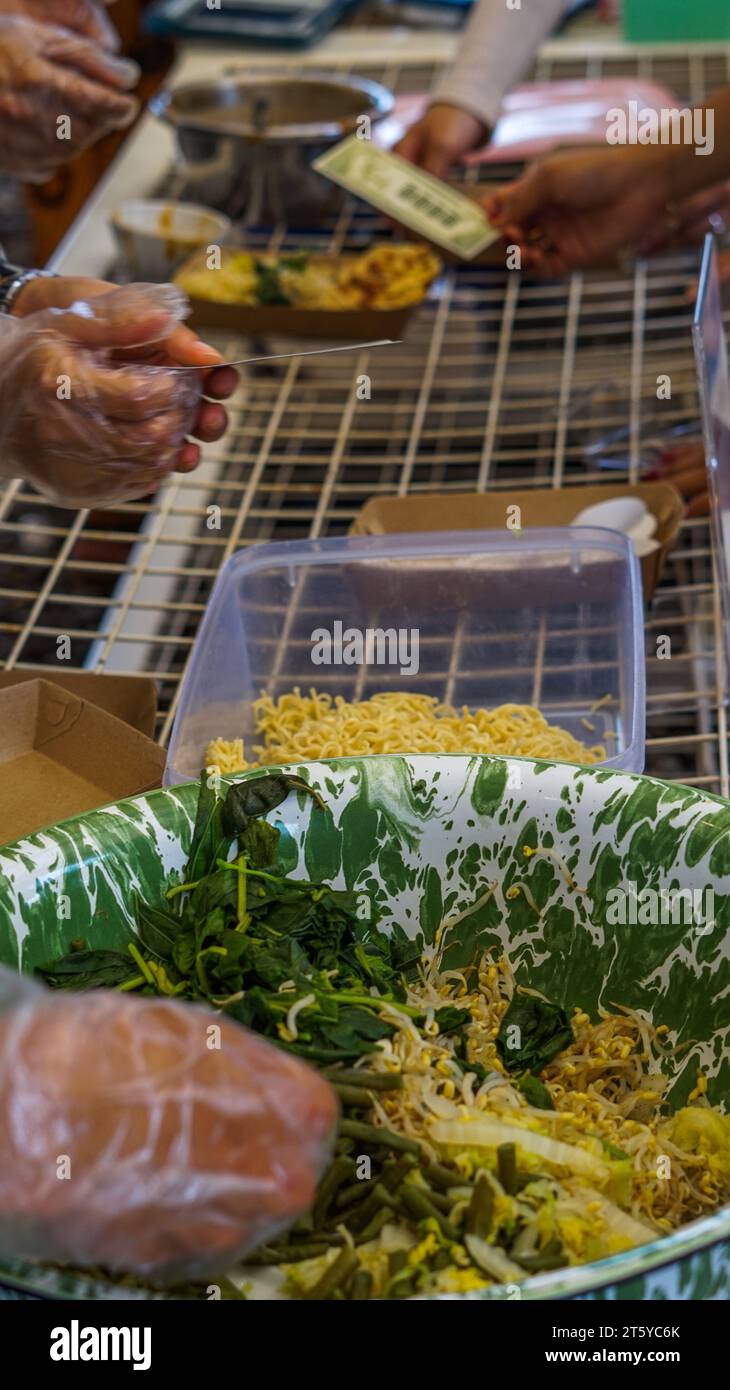 yellow noodles and boiled vegetables such as bean sprouts, spinach ...