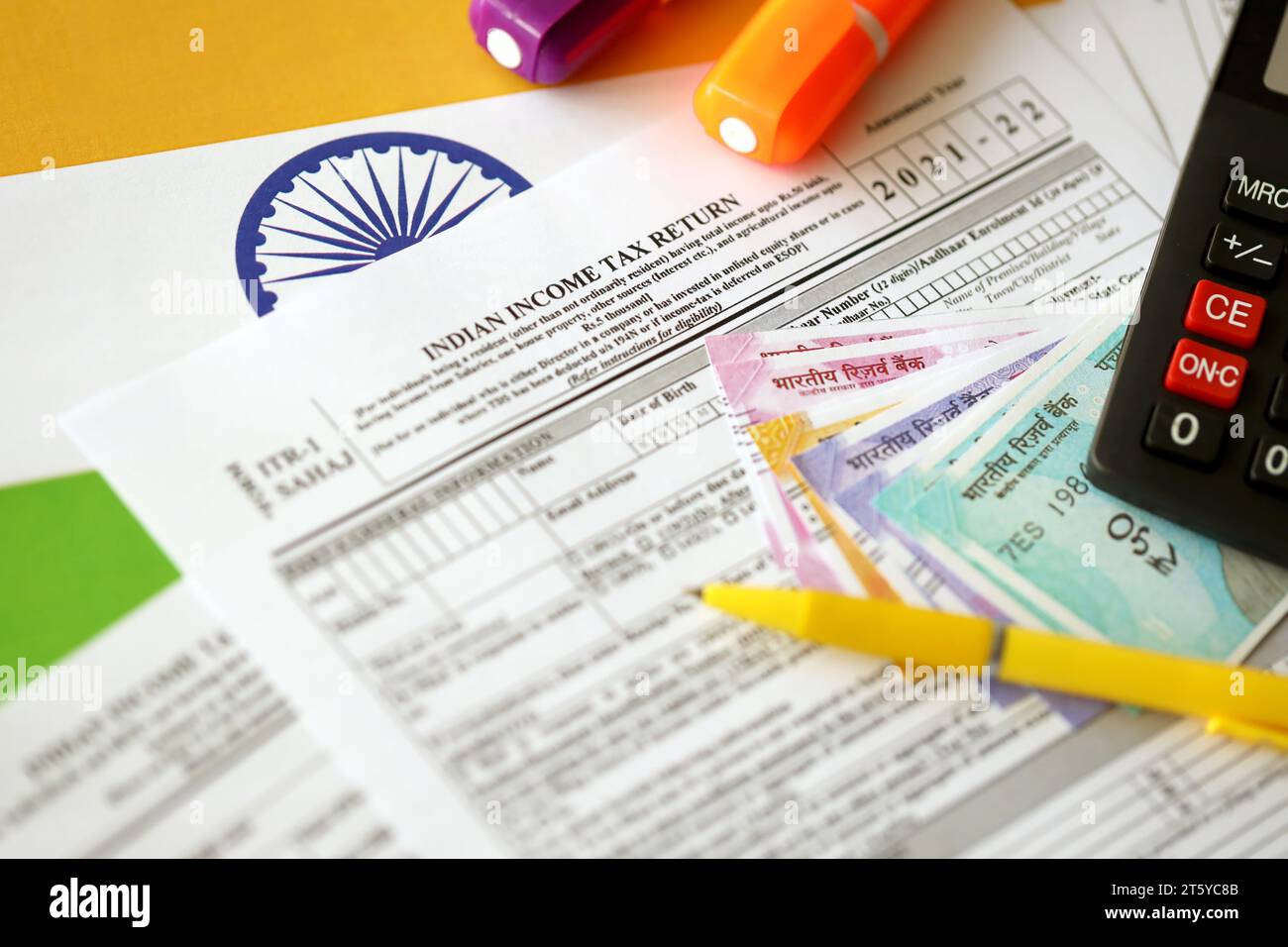 Indian income tax return blank form with pen and indian rupees bills on ...
