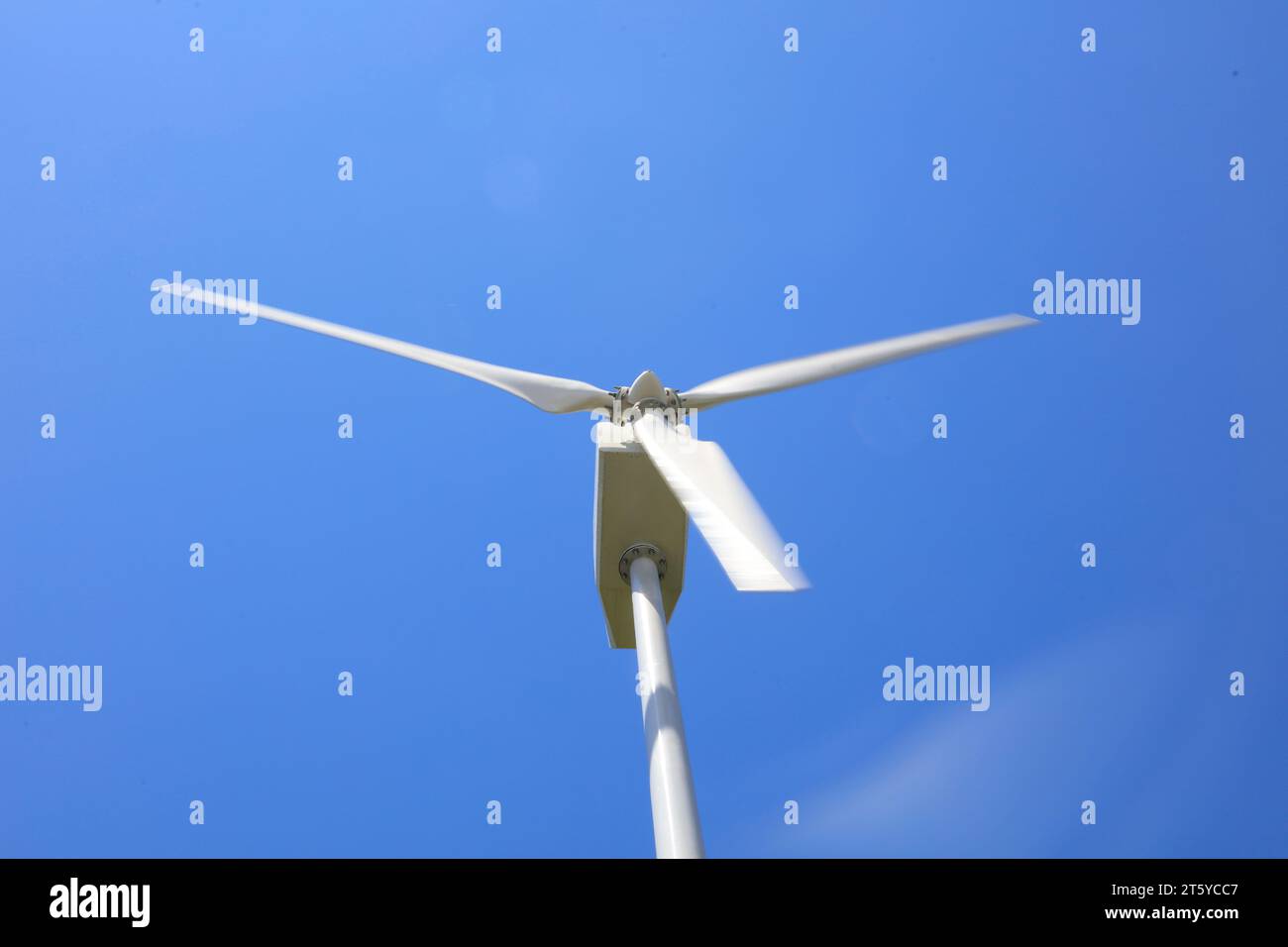 wind driven generator under blue sky Stock Photo - Alamy