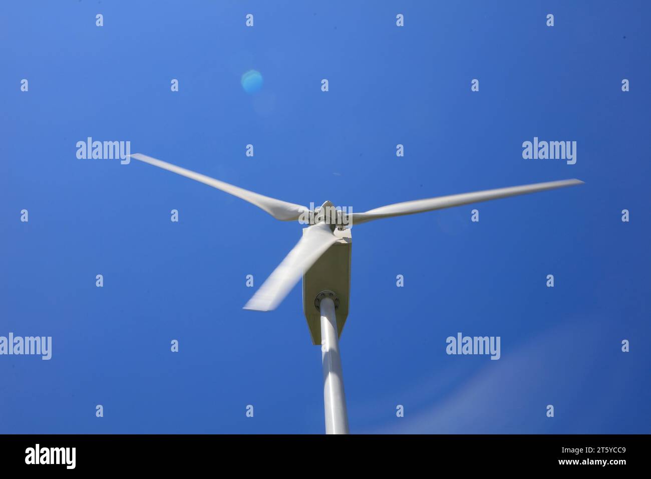 wind driven generator under blue sky Stock Photo - Alamy