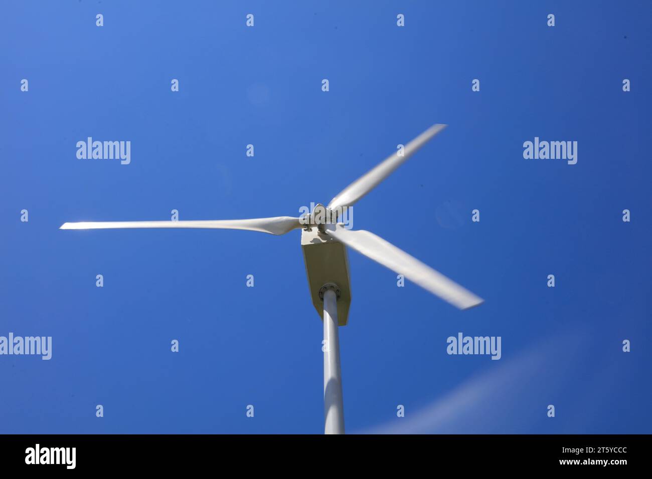 wind driven generator under blue sky Stock Photo - Alamy