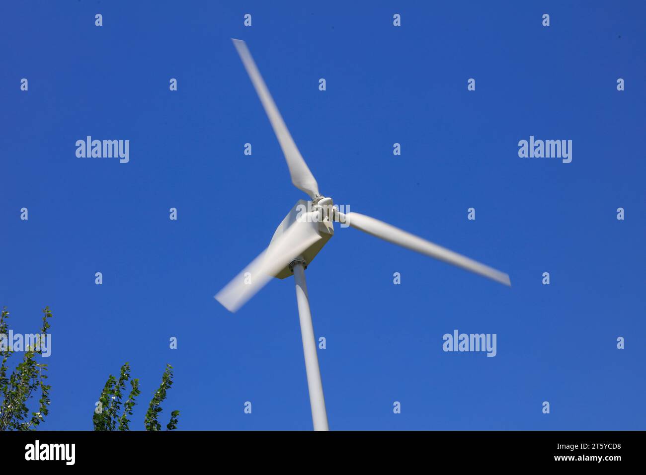 wind driven generator under blue sky Stock Photo - Alamy