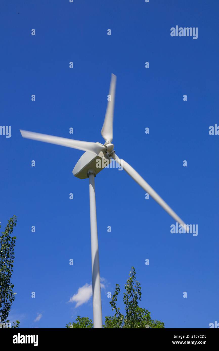 wind driven generator under blue sky Stock Photo - Alamy