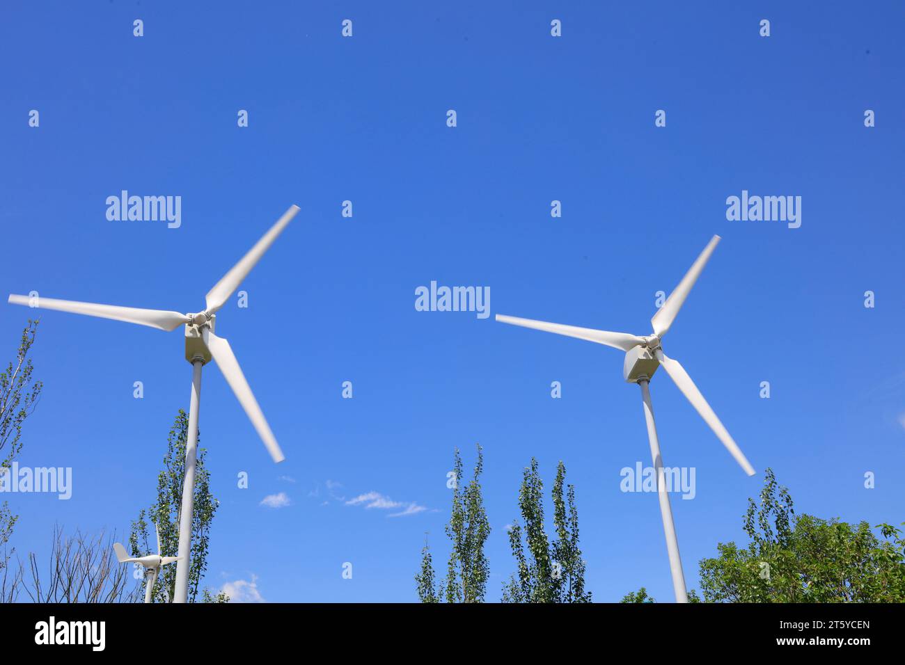 wind driven generator under blue sky Stock Photo - Alamy