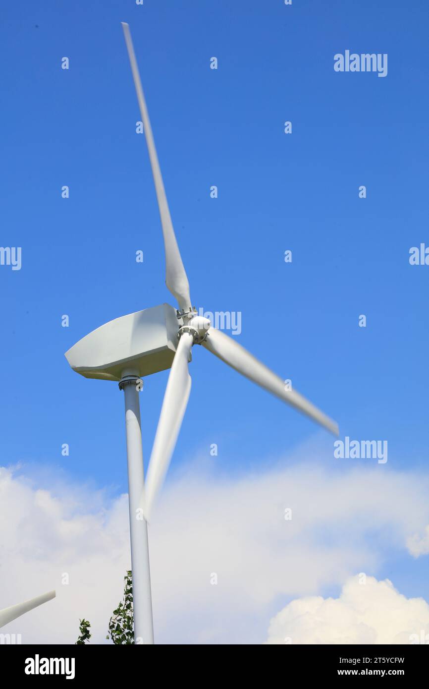 wind driven generator under blue sky Stock Photo - Alamy