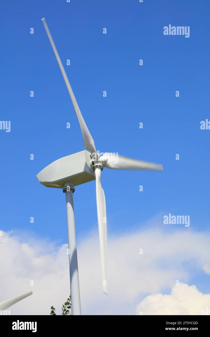 wind driven generator under blue sky Stock Photo - Alamy