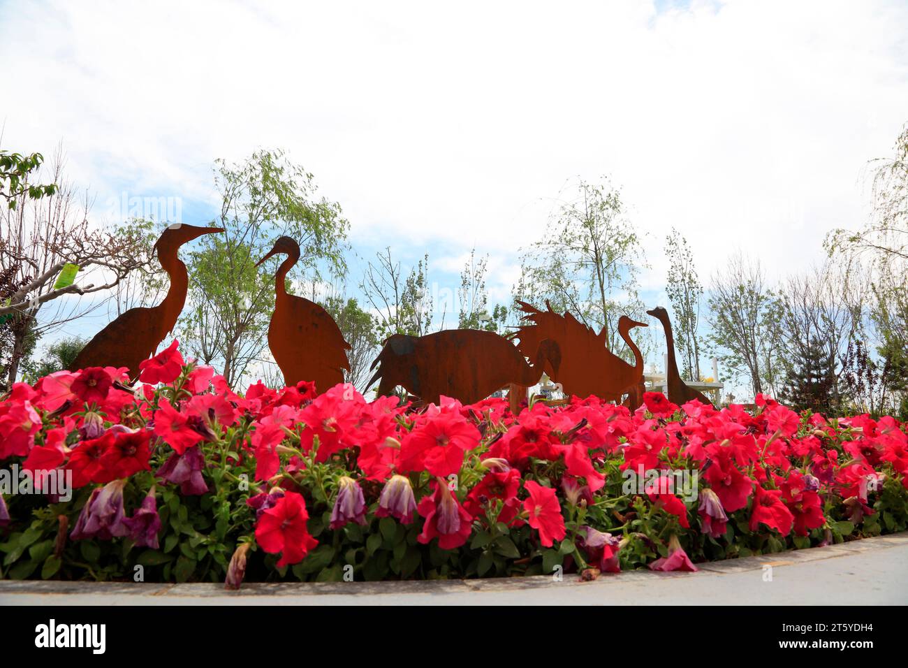 crane sculpture and flowers Stock Photo - Alamy
