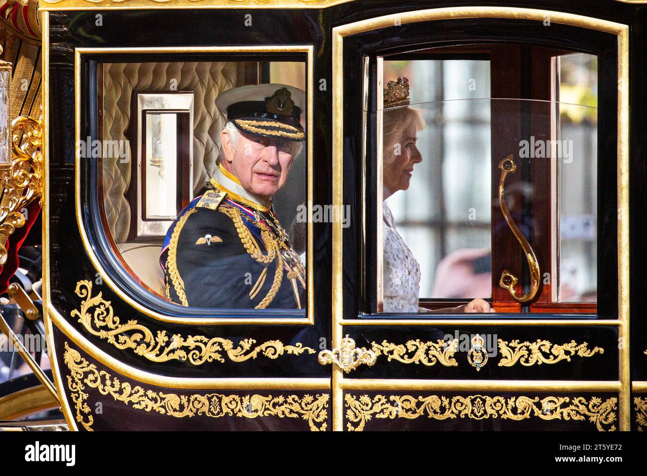 King Charles and Queen Camilla travel in a horse drawn carriage towards ...