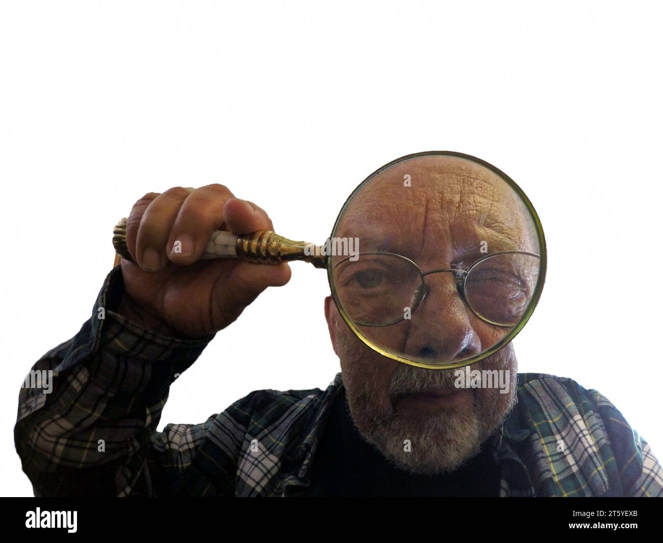 Man looking through a hand held magnifying glass and also wearing ...