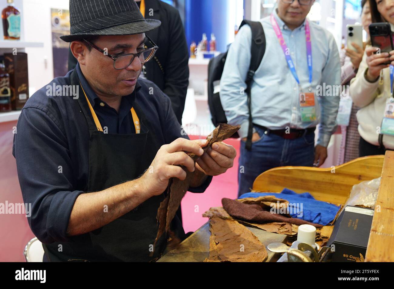 Shanghai. 7th Nov, 2023. An exhibitor displays cigar-making technique ...