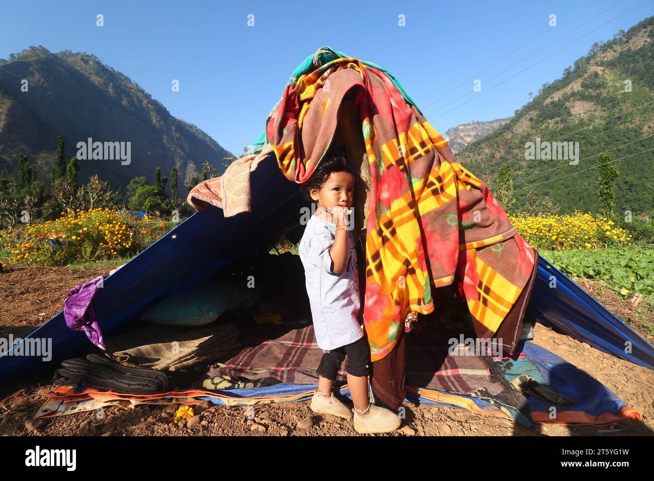 West Rukum, Karnali, Nepal. 7th Nov, 2023. A child stands in front of temporary make shift ...