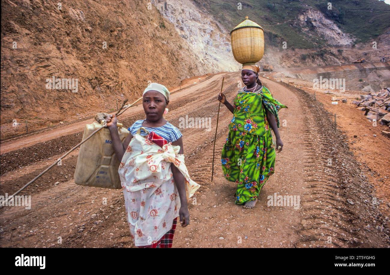 Rwanda, woman walk over a road built by a Chinese construction company ...