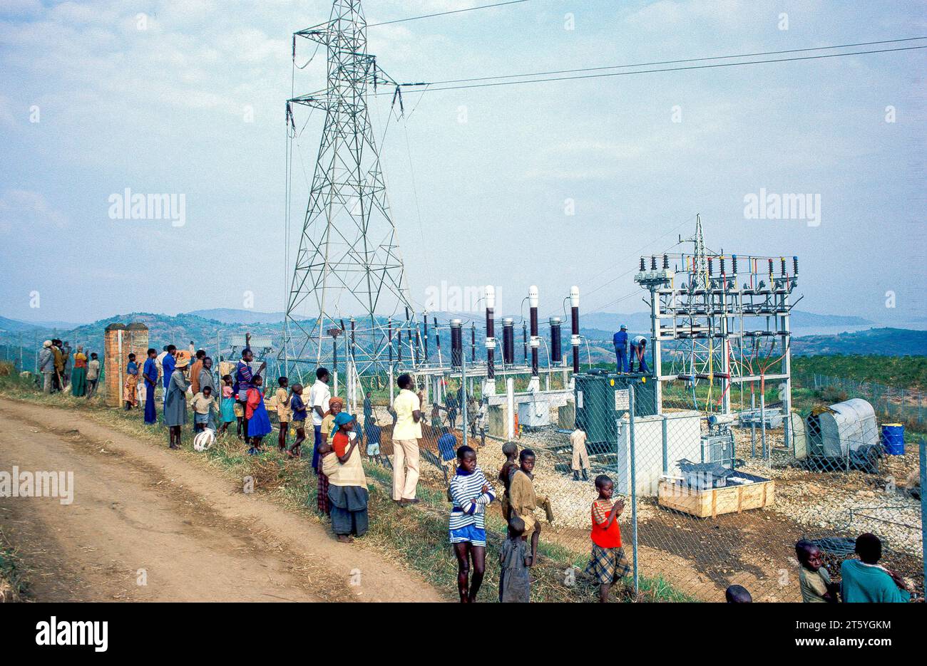 Rwanda, Kigali region; people watching a fenced electricity station ...